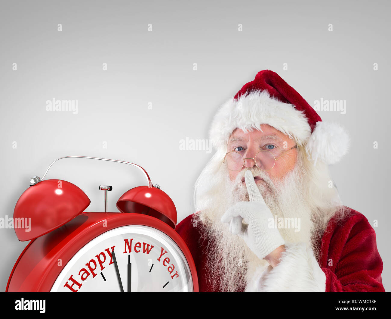 Santa asking for quiet to camera against grey vignette Stock Photo - Alamy