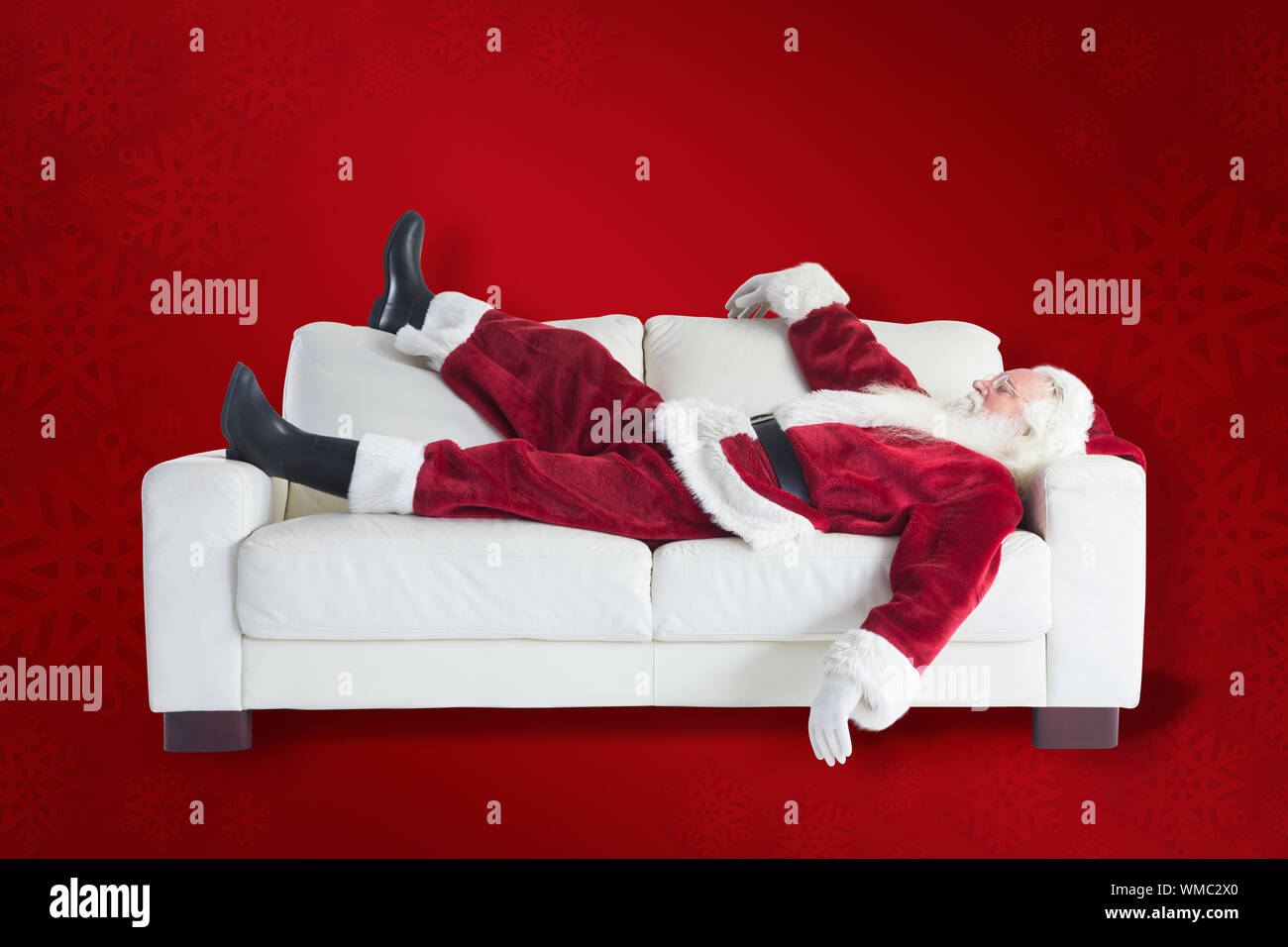 Santa Claus taking a nap against red background Stock Photo - Alamy