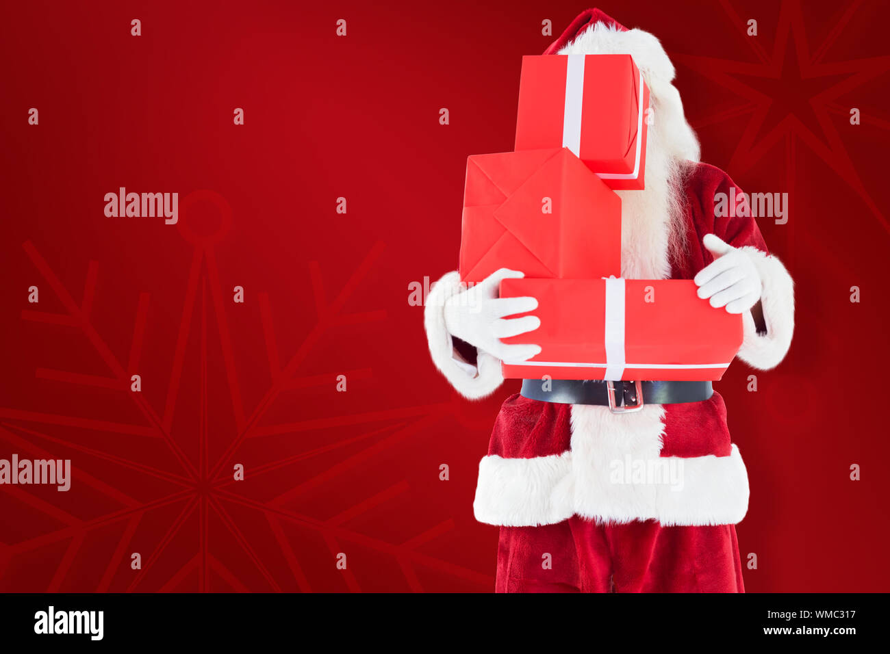 Santa covers his face with presents against red background Stock Photo ...