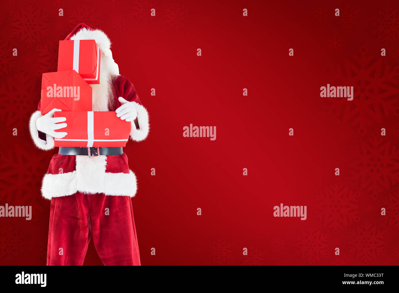Santa covers his face with presents against red background Stock Photo ...