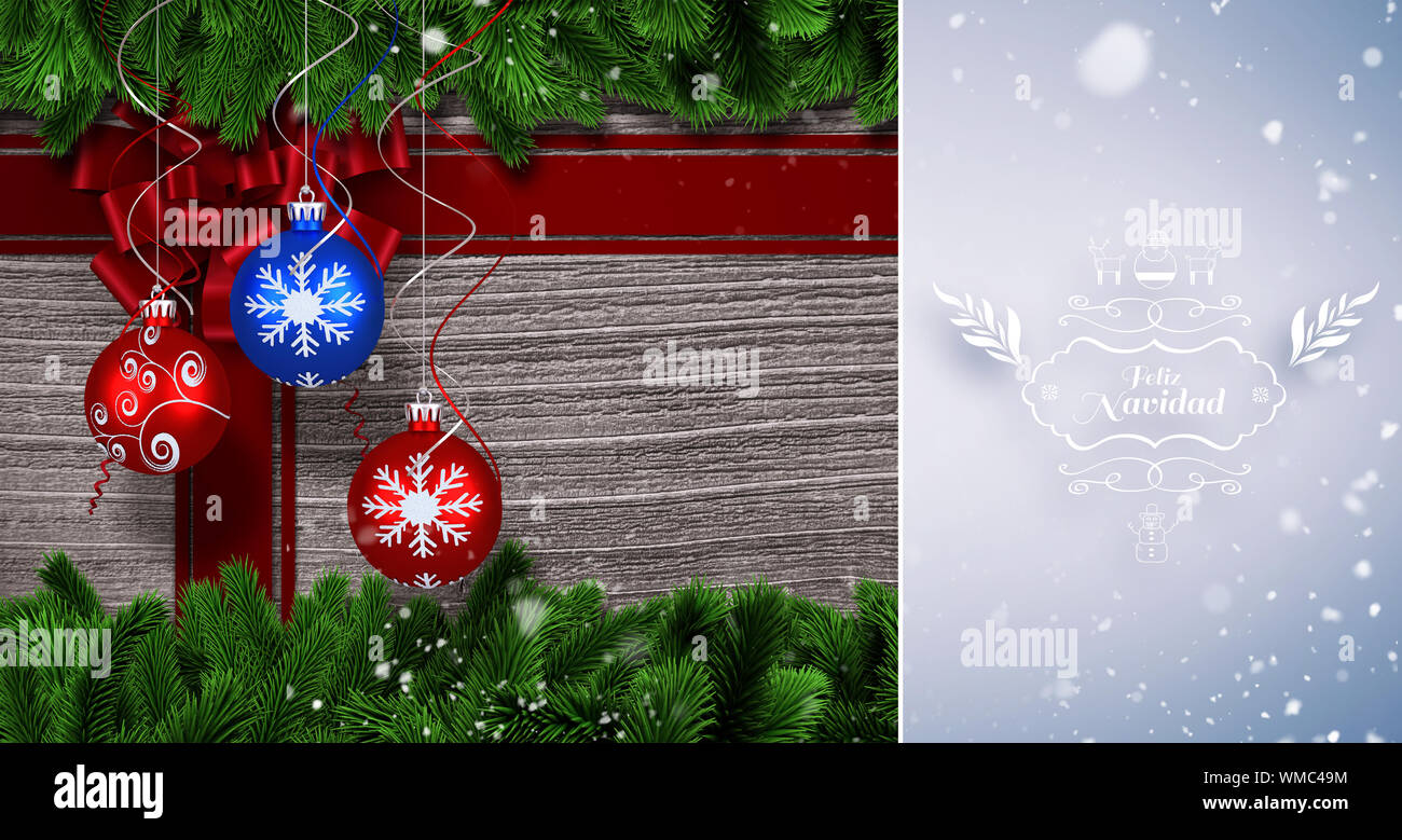 Snow falling against christmas baubles hanging over wood Stock Photo ...