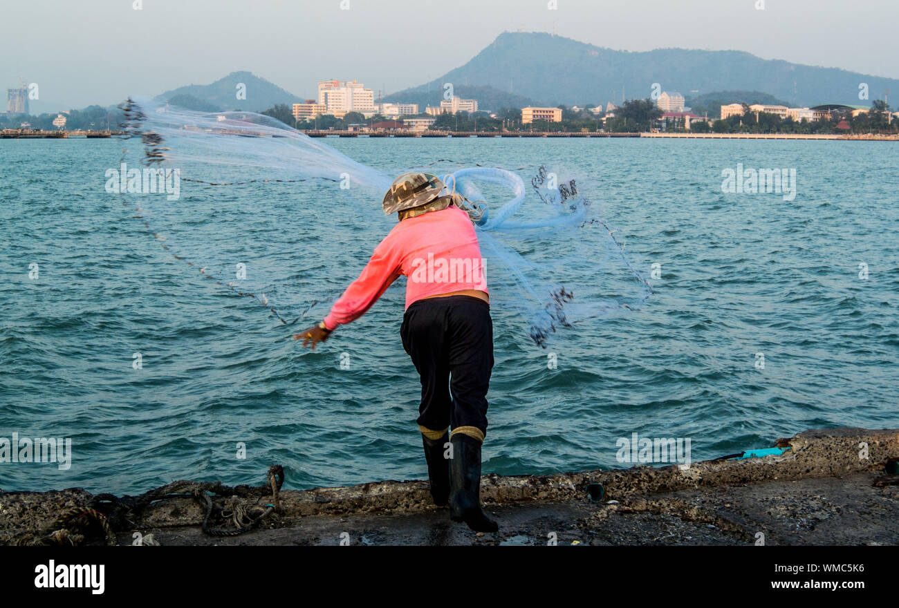 Man Throwing Fishing Net Into Water Stock Photos & Man Throwing Fishing ...