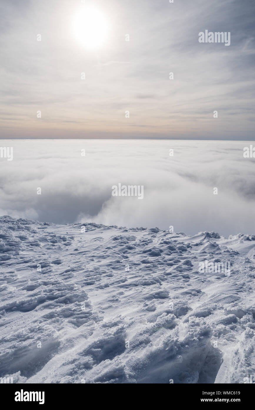 Mountain tops covered with snow above the white heavy clouds Stock ...