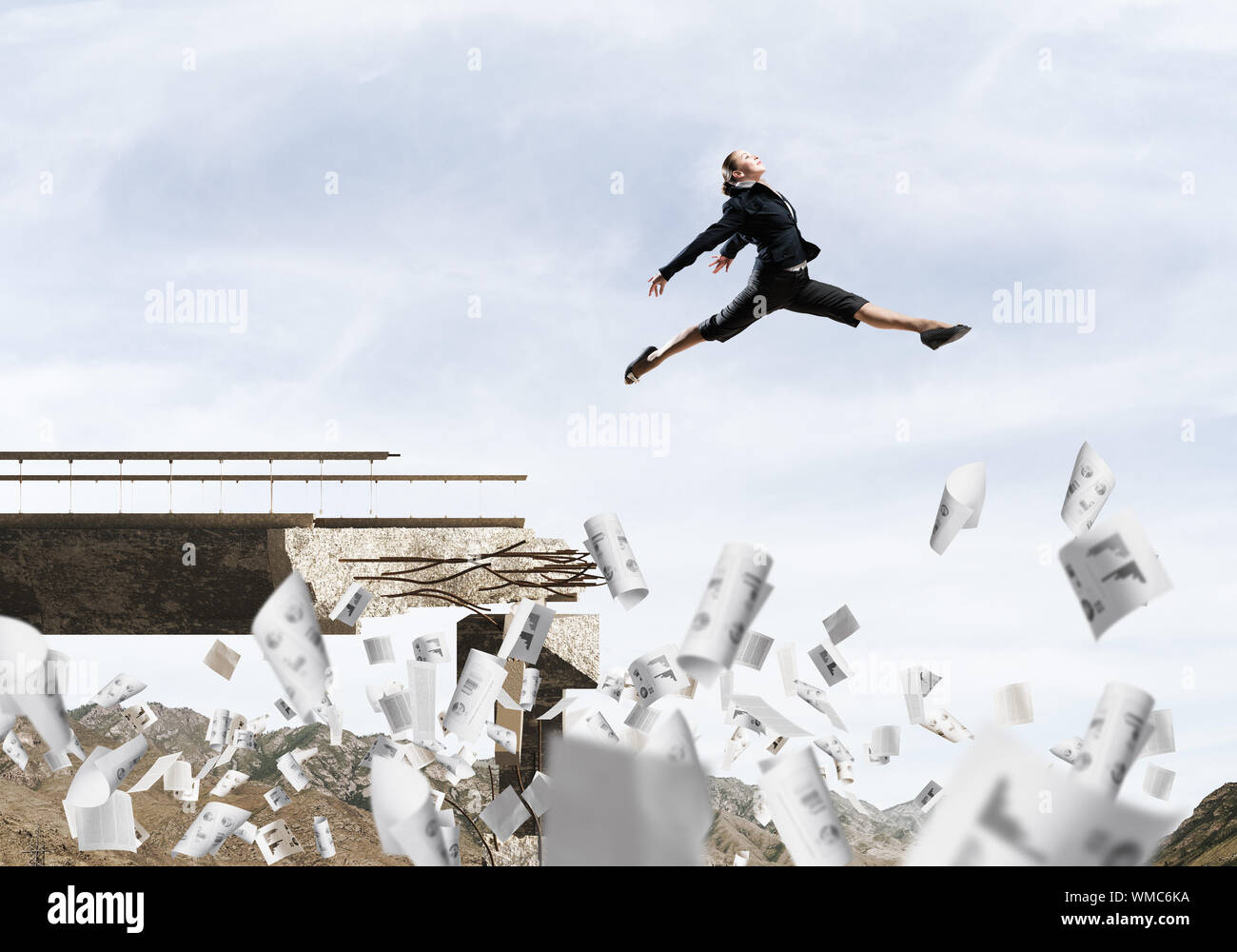 Business woman jumping over gap in bridge among flying papers as symbol ...