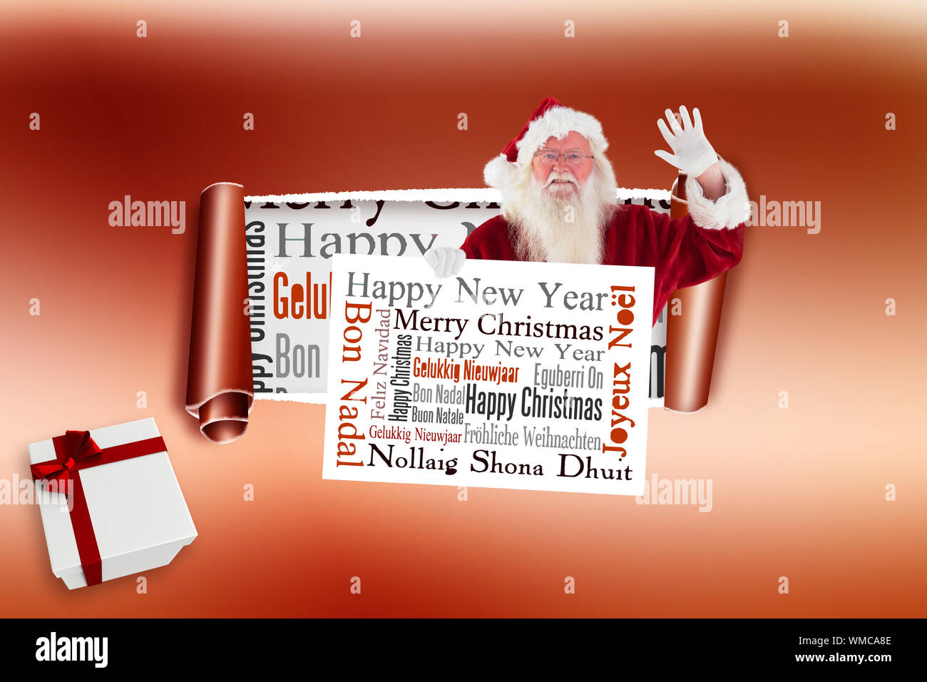 Santa holds a sign and is waving through rip in gold paper Stock Photo ...