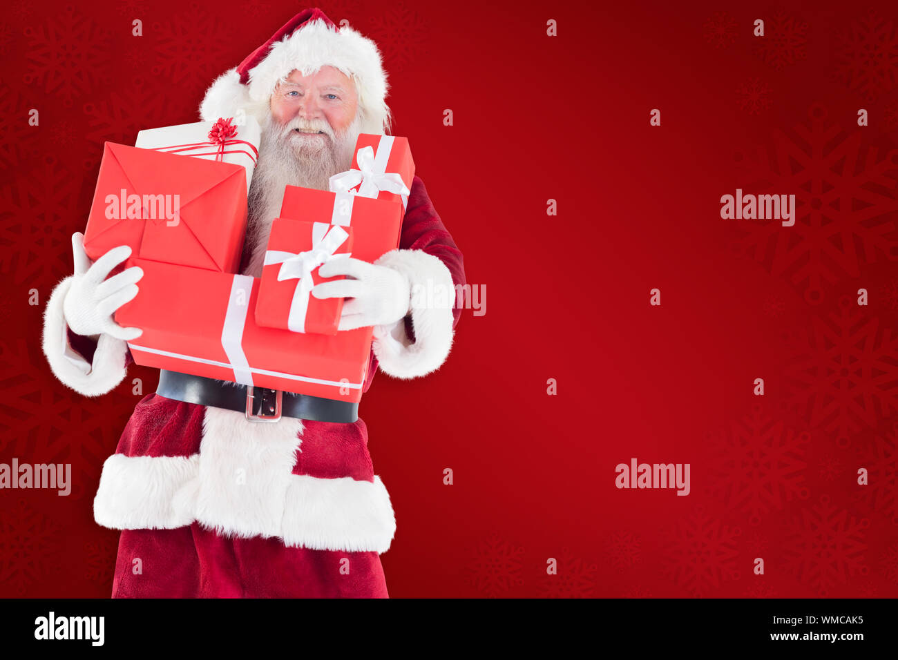 Santa carries a few presents against red background Stock Photo - Alamy