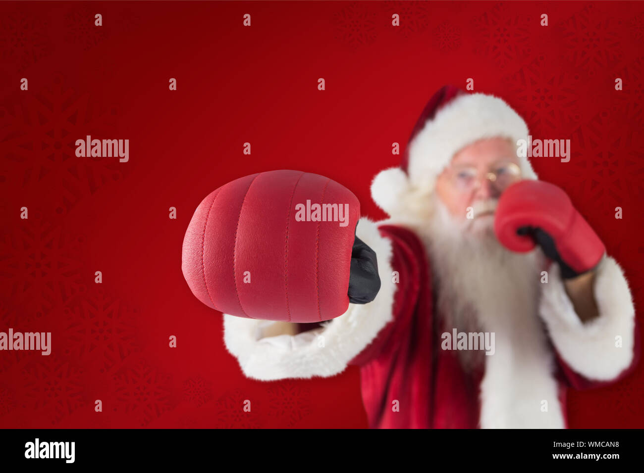 Santa Claus punches with his right against red background Stock Photo ...