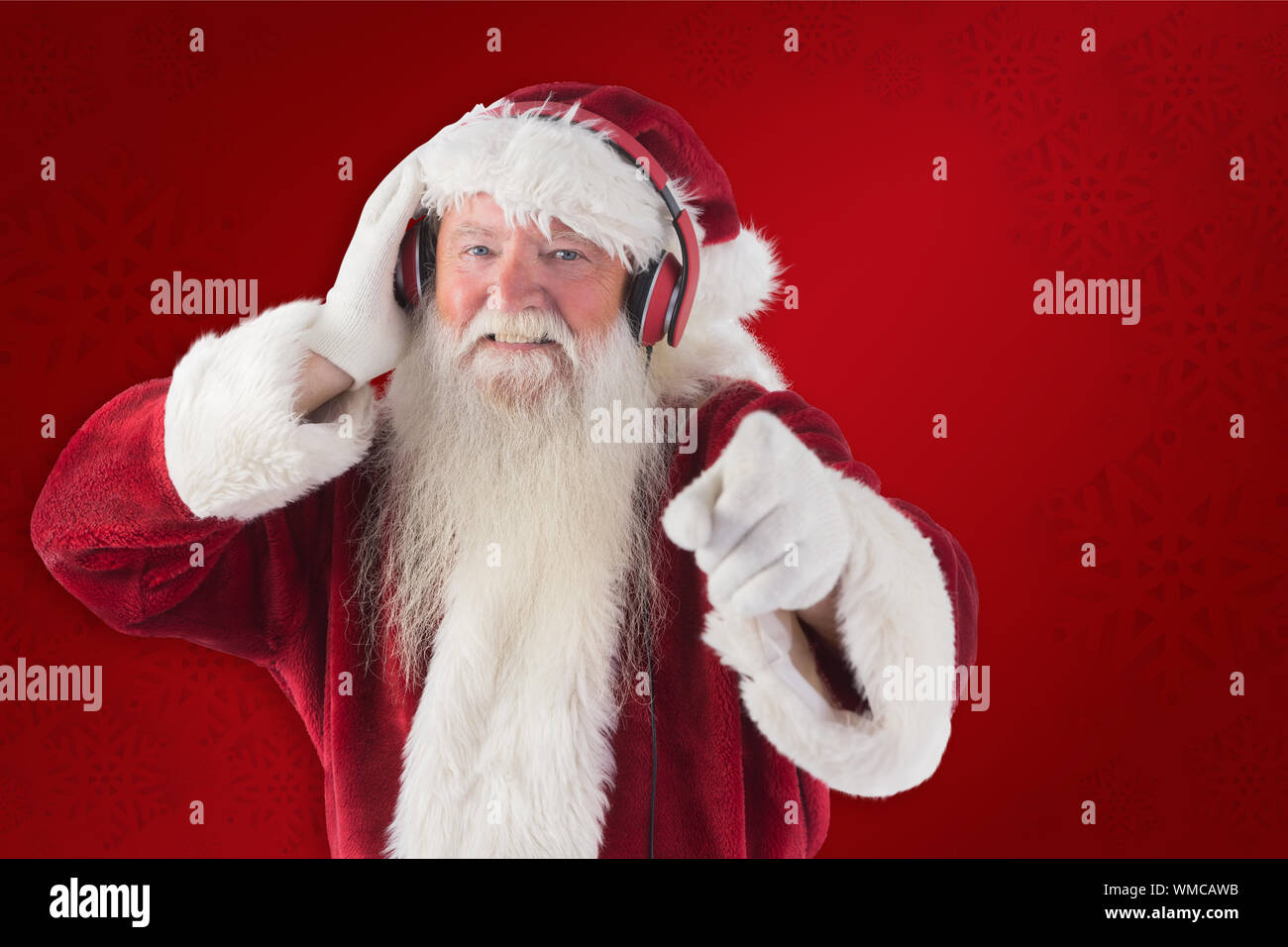 Santa is listening some music against red background Stock Photo - Alamy