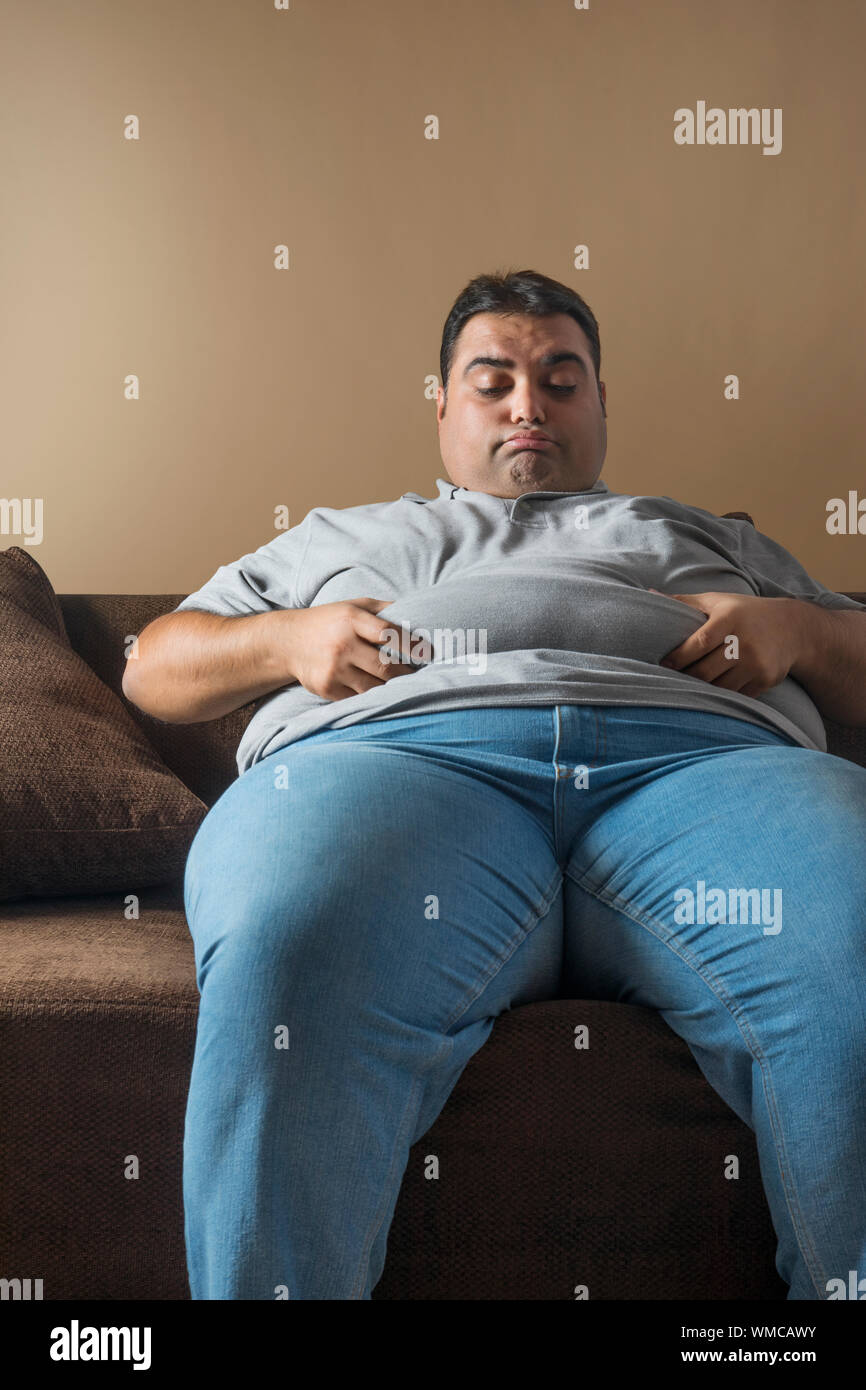 Fat obese stomach sitting hi-res stock photography and images - Alamy