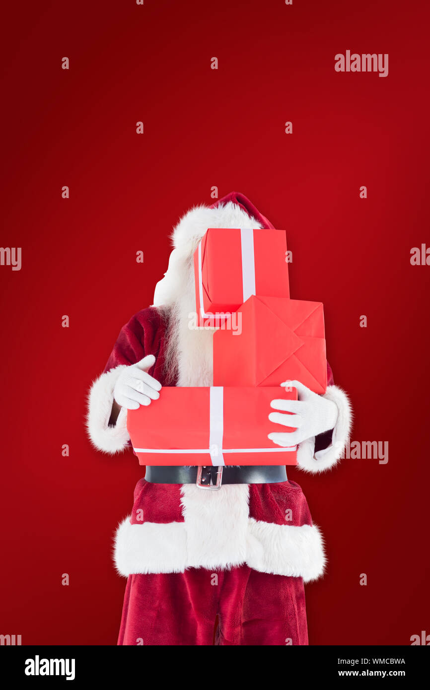Santa covers his face with presents against red background Stock Photo ...