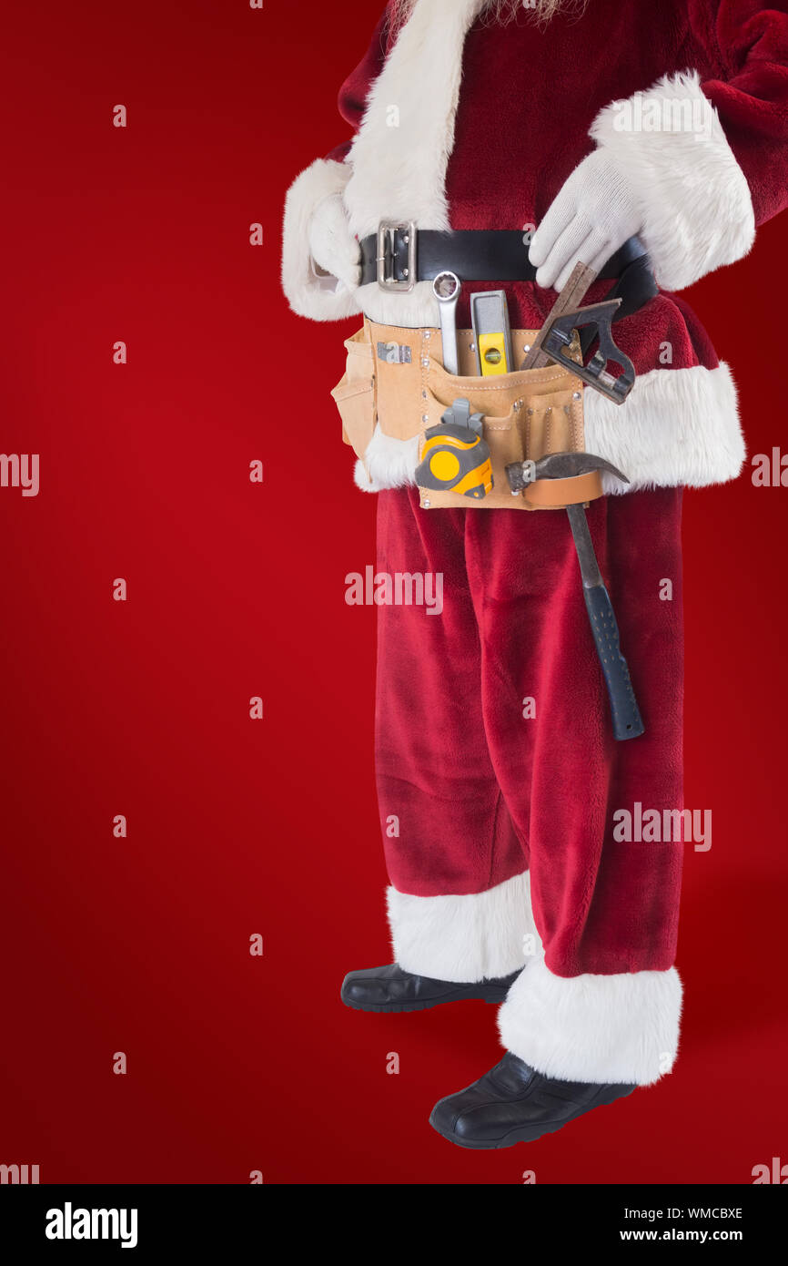 Father Christmas is wearing a tool belt against red background Stock ...