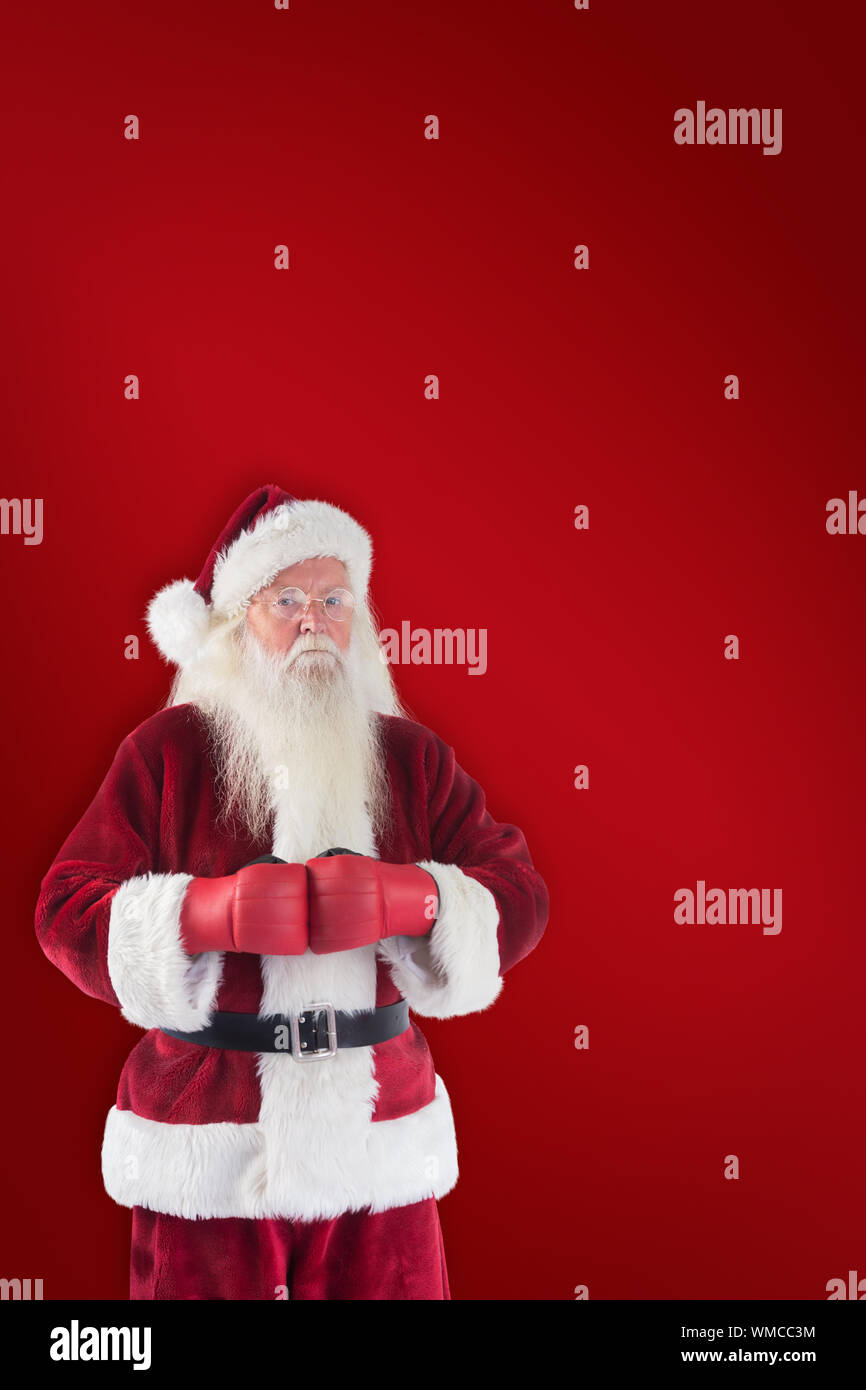 Santa Claus wears boxing gloves against red background Stock Photo - Alamy