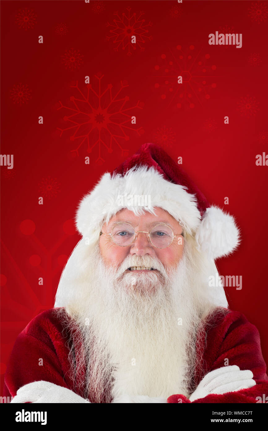 Santa smiles with folded arms against red background Stock Photo - Alamy