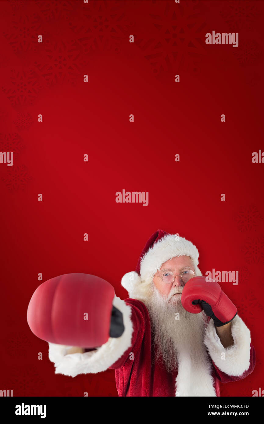 Santa Claus punches with his right against red background Stock Photo ...