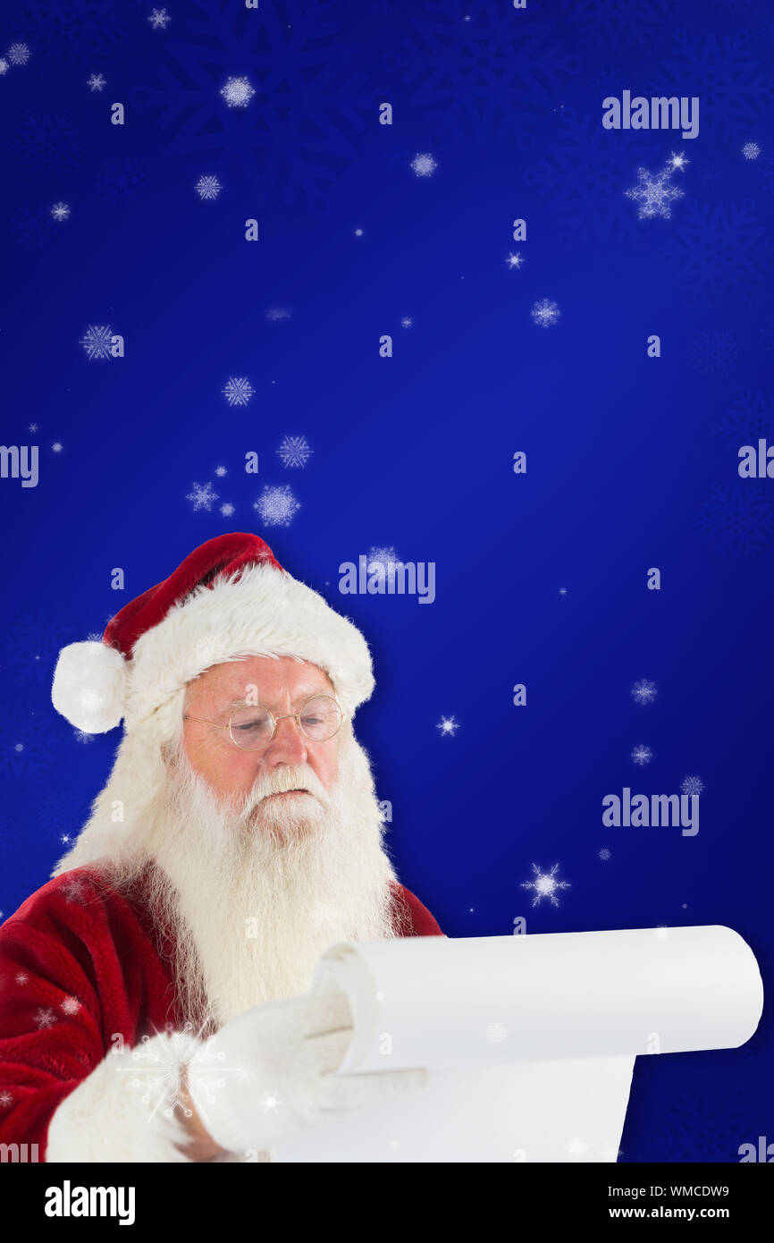 Santa claus checking his list against blue snowflake background Stock ...