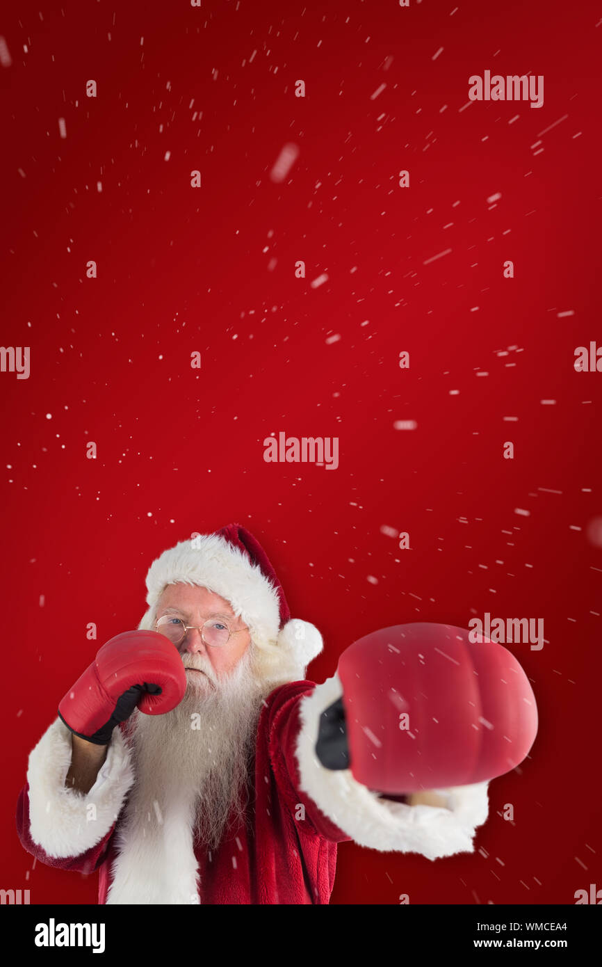 Santa Claus punches with his right against red background Stock Photo ...
