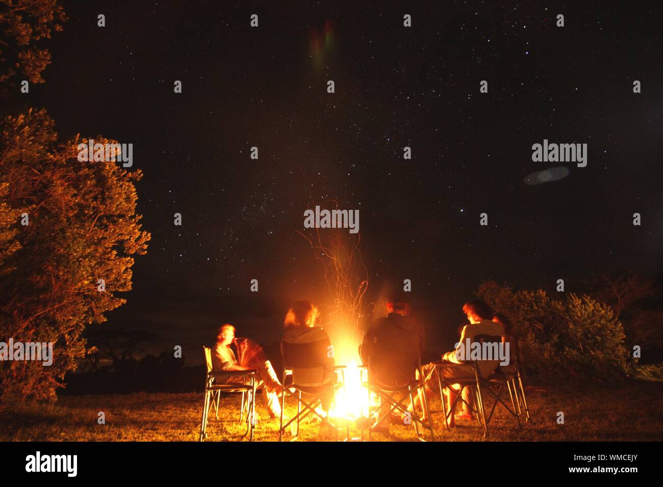 People Sitting Around Campfire Night High Resolution Stock Photography ...