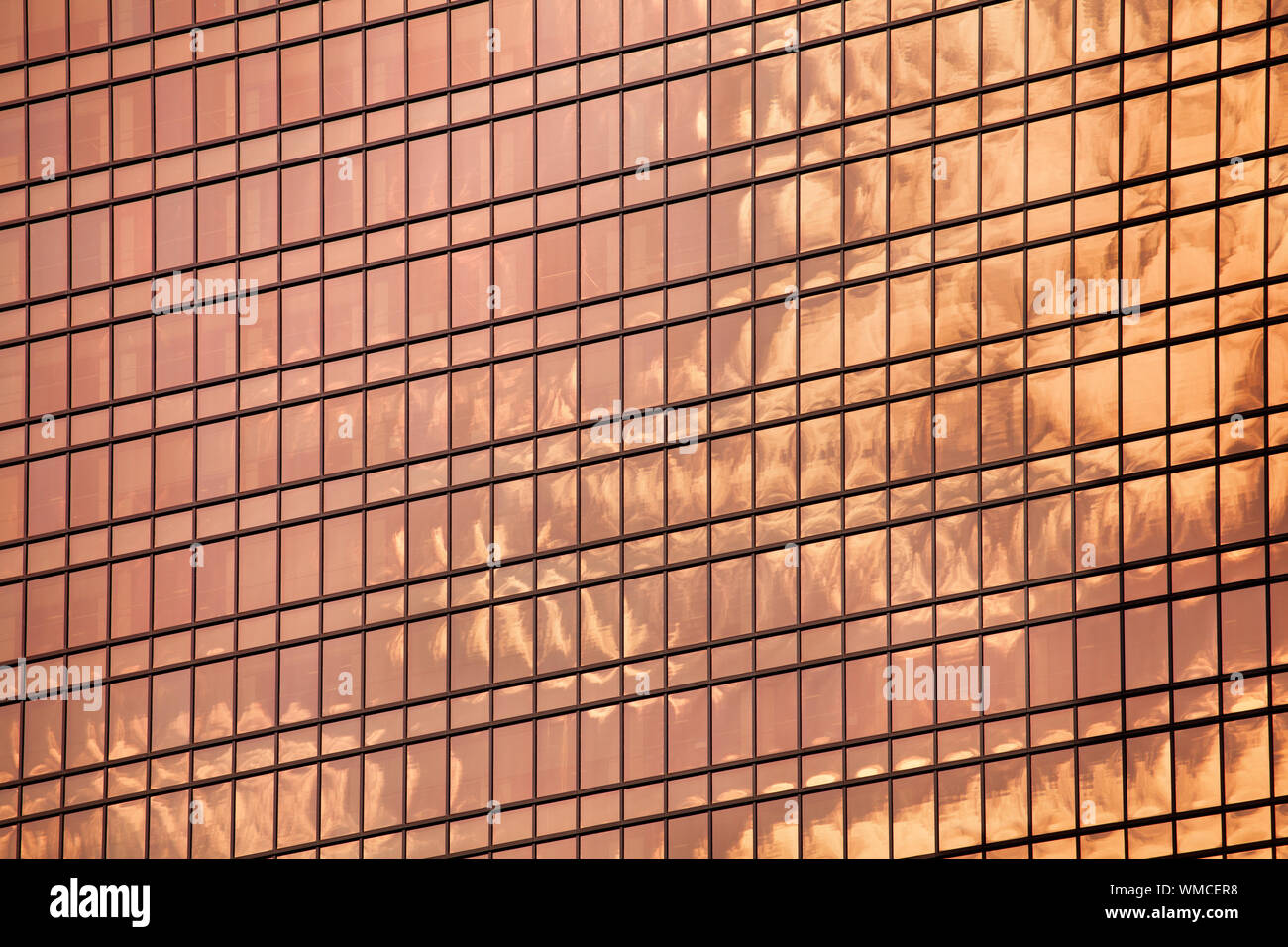 Red glass skyscraper wall surface close up, modern business center view ...