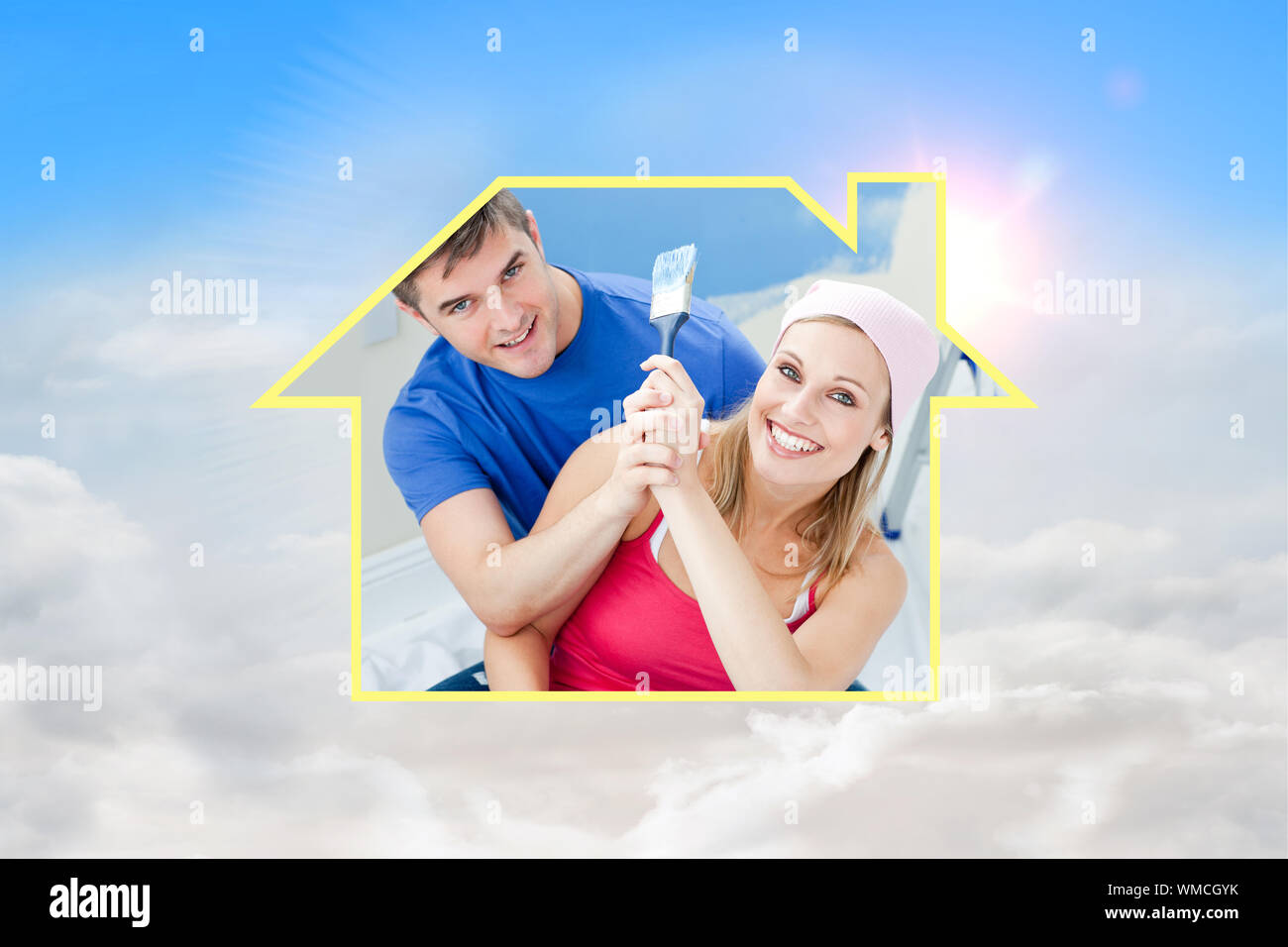 Hugging couple having fun while painting a room against blue sky with ...
