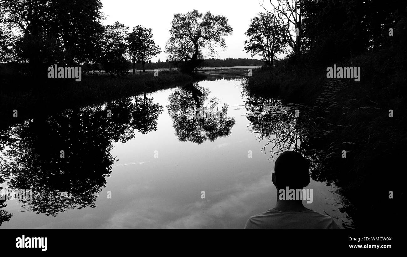 Man Looking Reflection In Water Black and White Stock Photos & Images ...