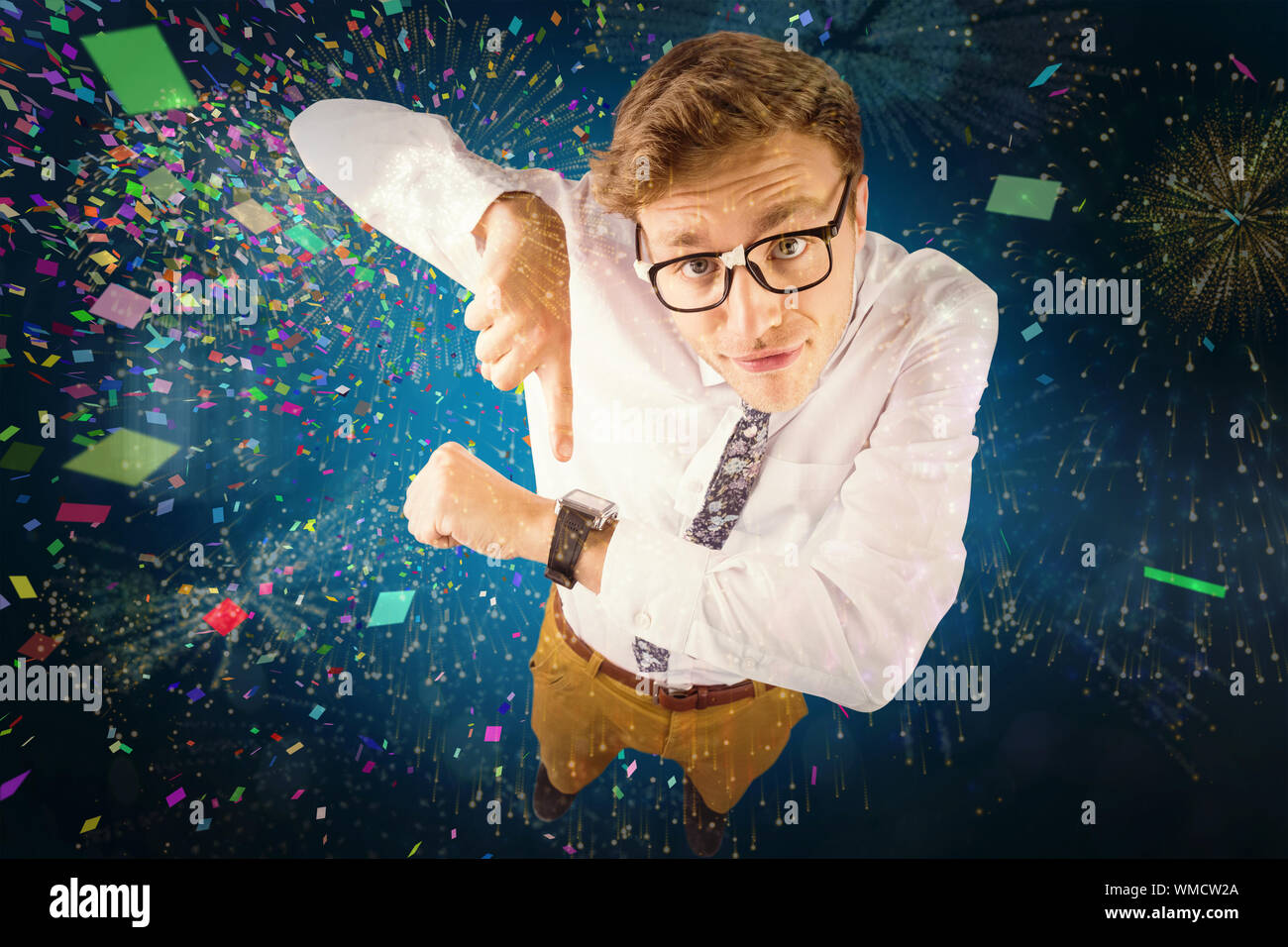 Geeky businessman pointing to watch against colourful fireworks ...