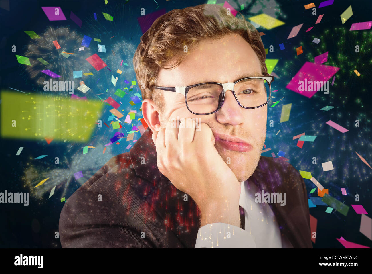 Young geeky businessman looking bored against colourful fireworks ...