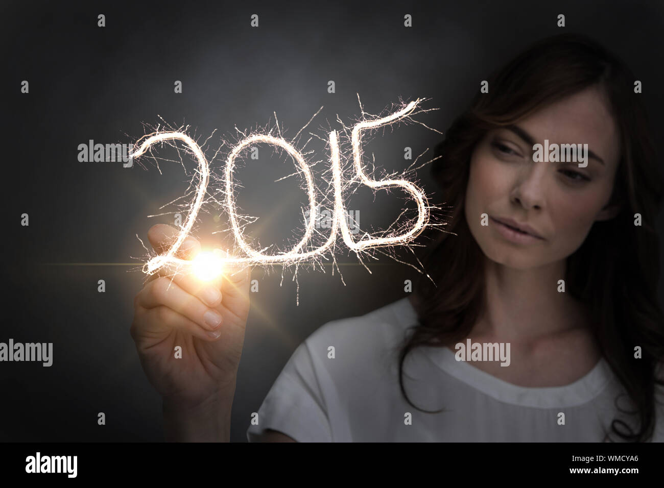 Businesswoman touching spark against dark background Stock Photo - Alamy