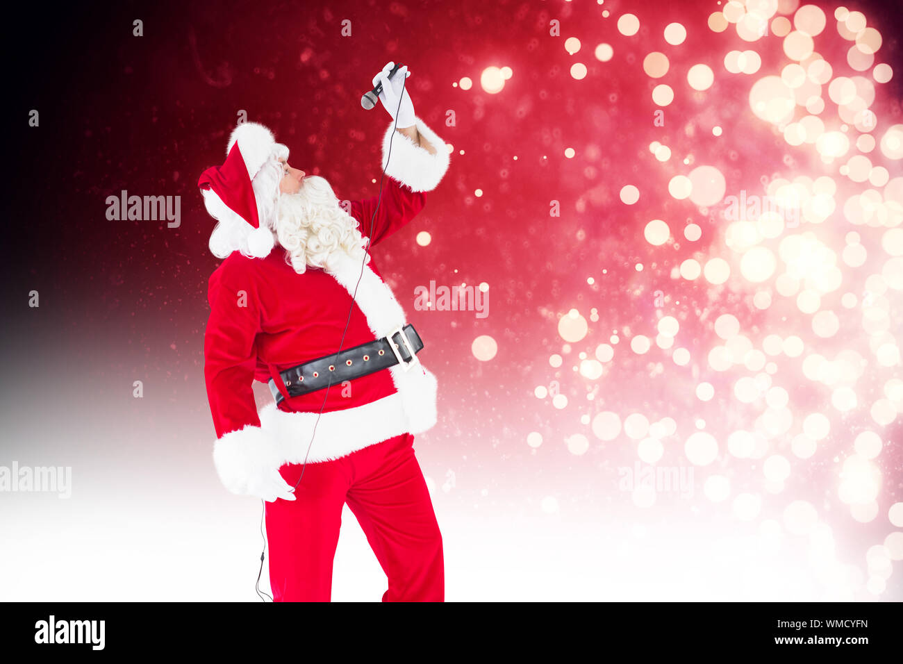 Happy santa claus singing microphone hi-res stock photography and ...