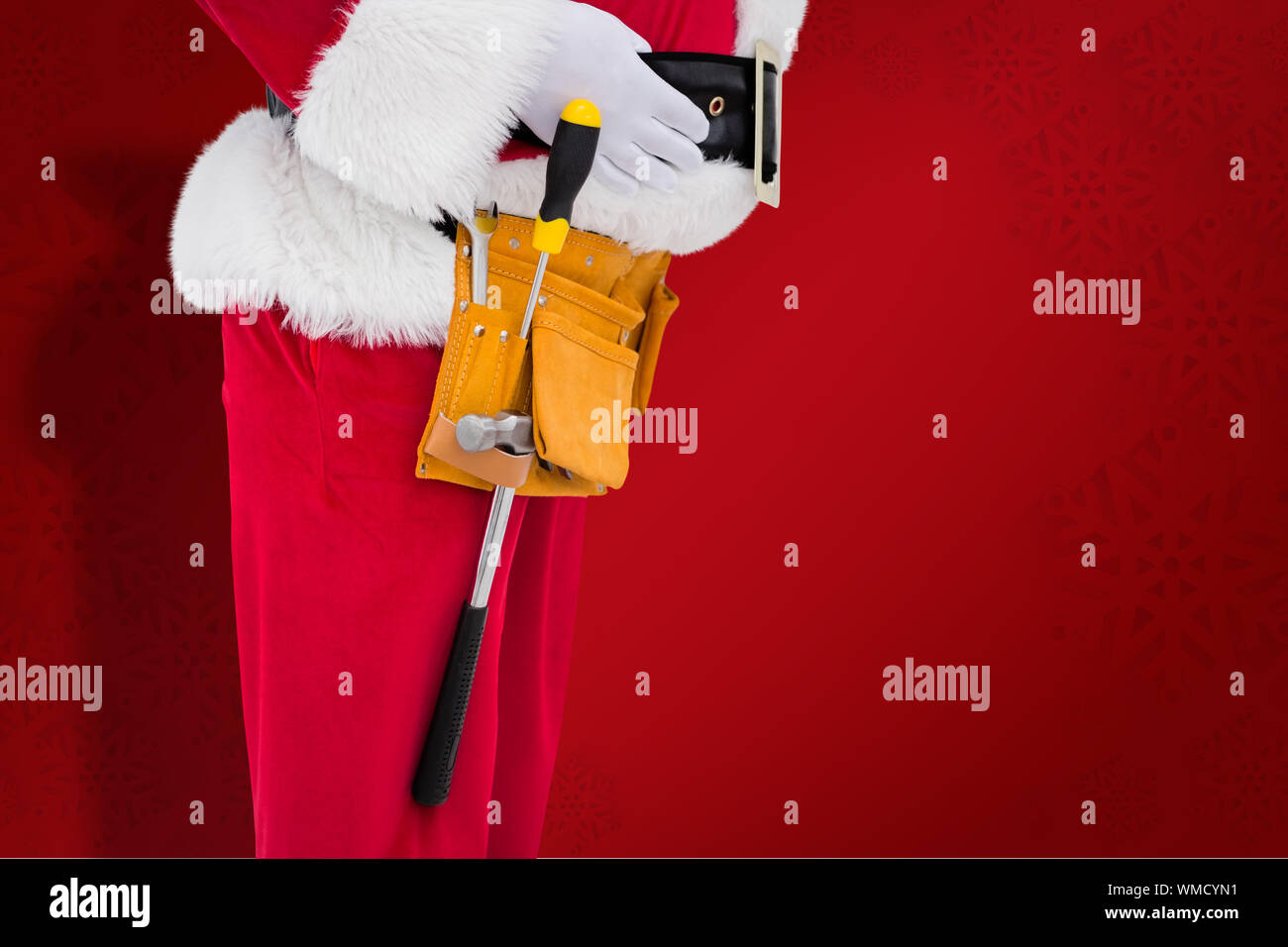 Santa claus with tool belt against red snowflake background Stock Photo ...