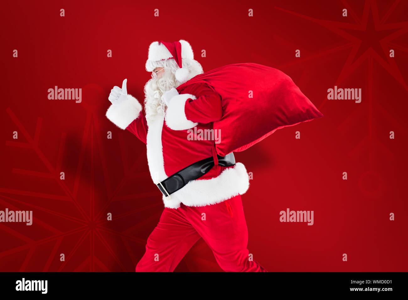 Positive santa with a sack and thumbs up against red snowflake ...