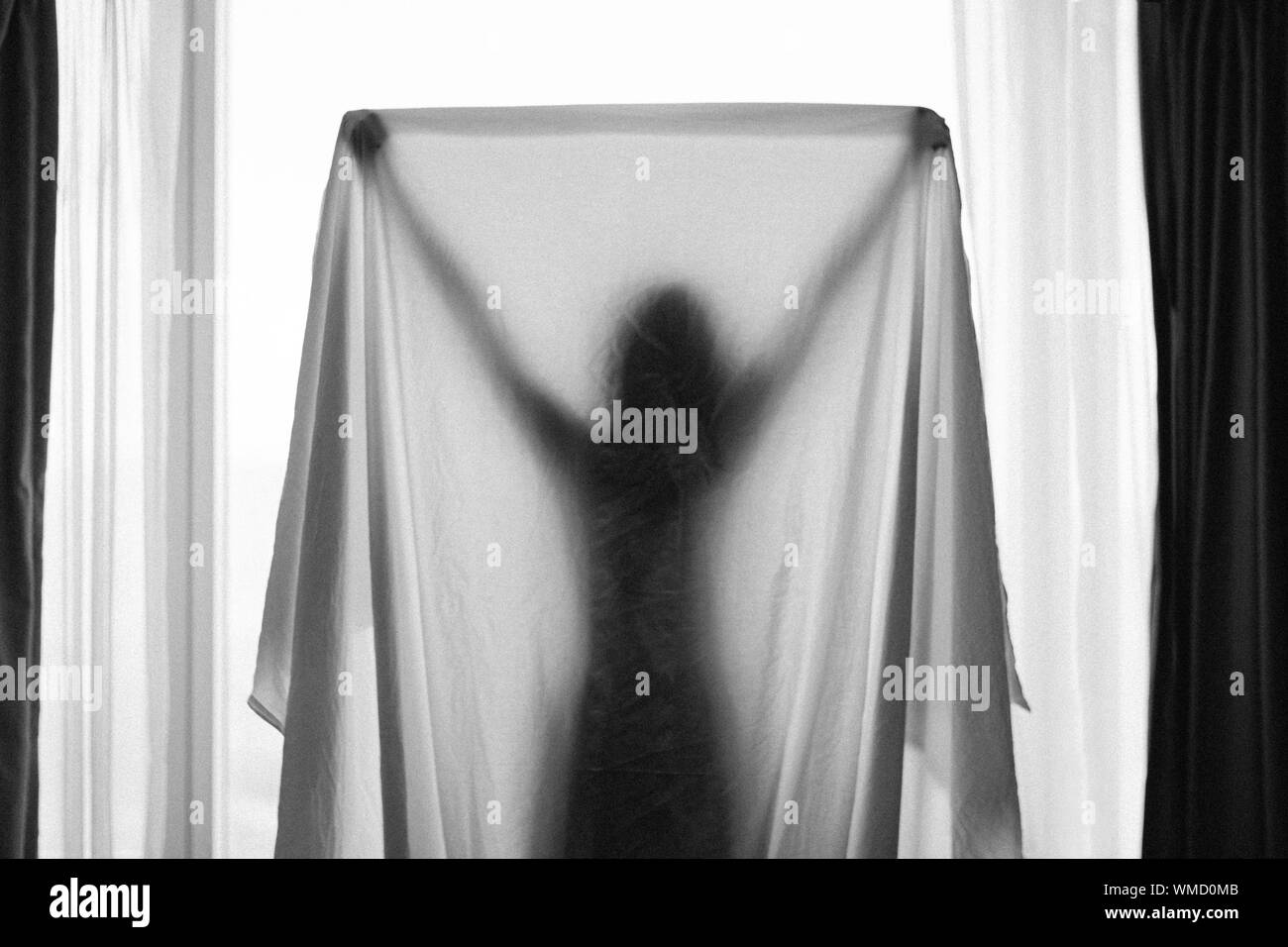 Arms raised holding Black and White Stock Photos & Images - Alamy