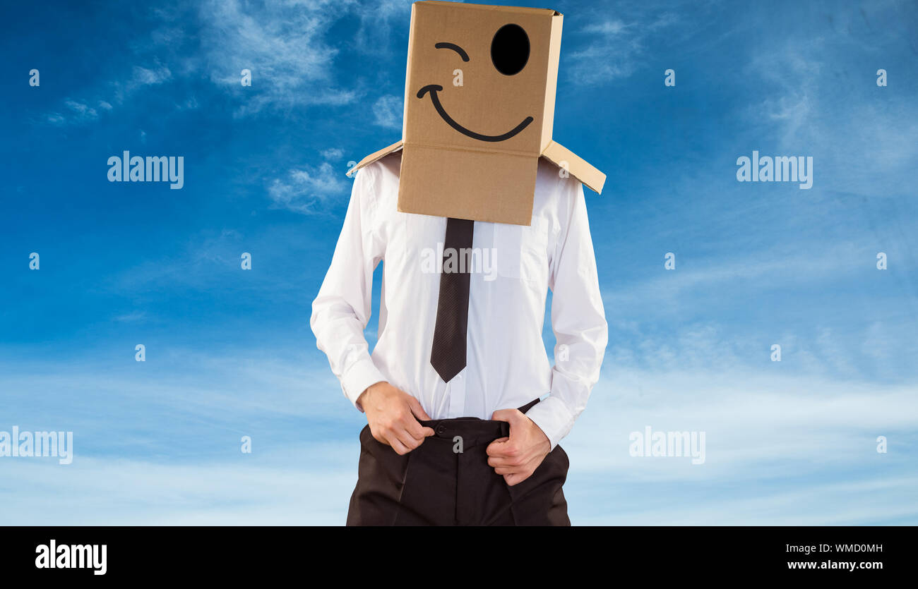 Anonymous businessman with hands in waistband against blue sky Stock ...