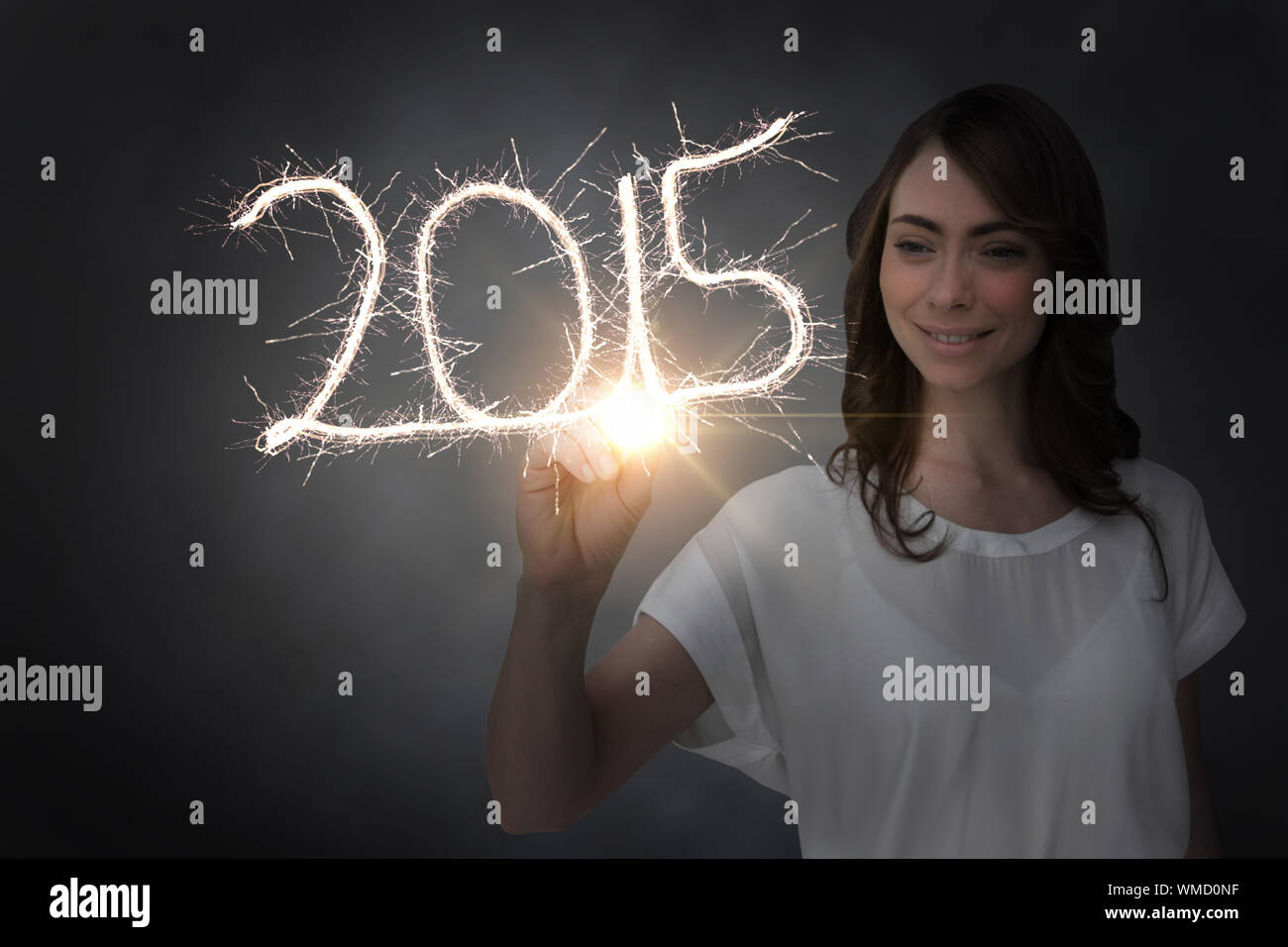 Businesswoman touching spark against dark background Stock Photo - Alamy