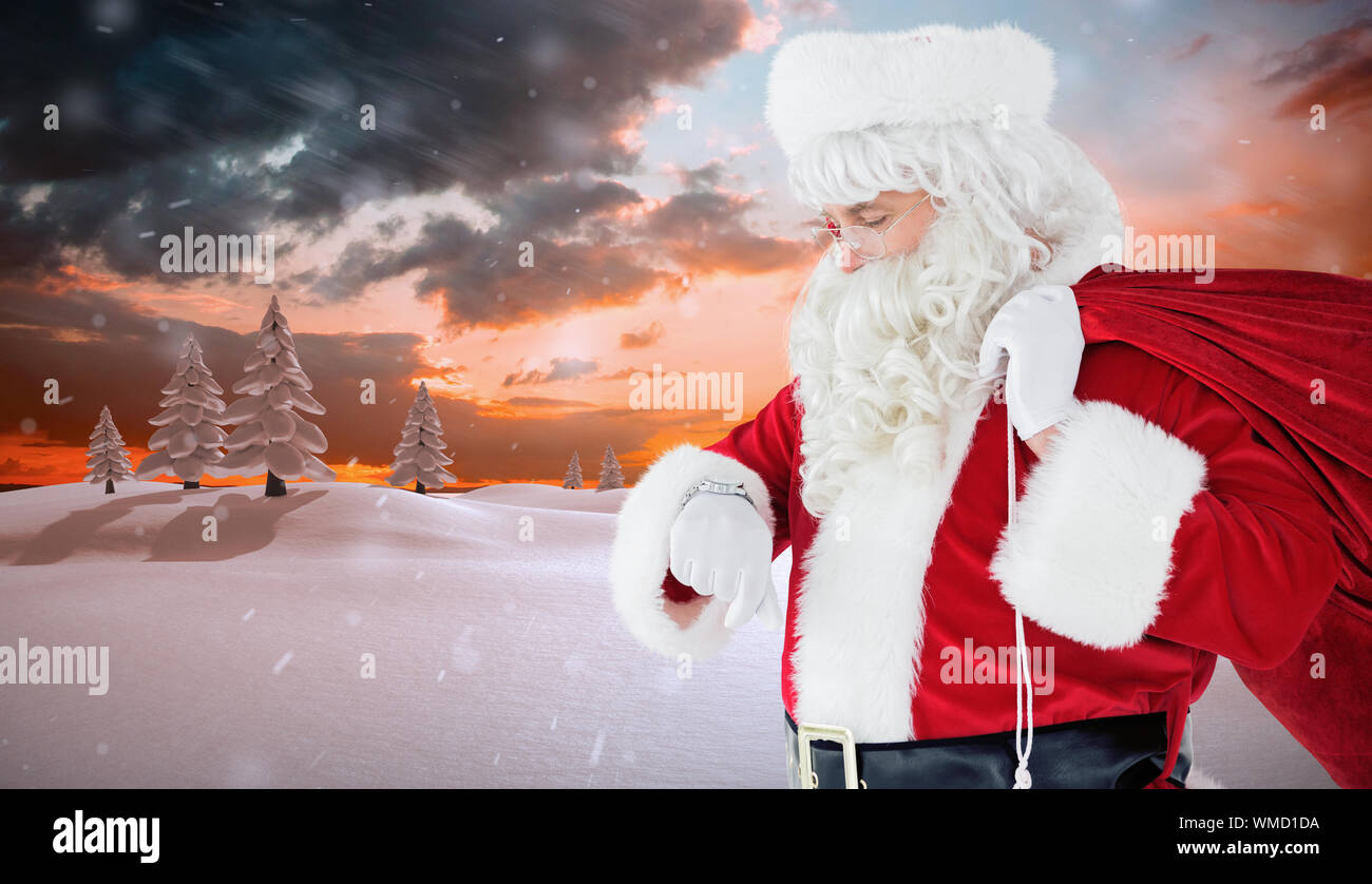 Festive santa claus checking time against snowy landscape with fir ...