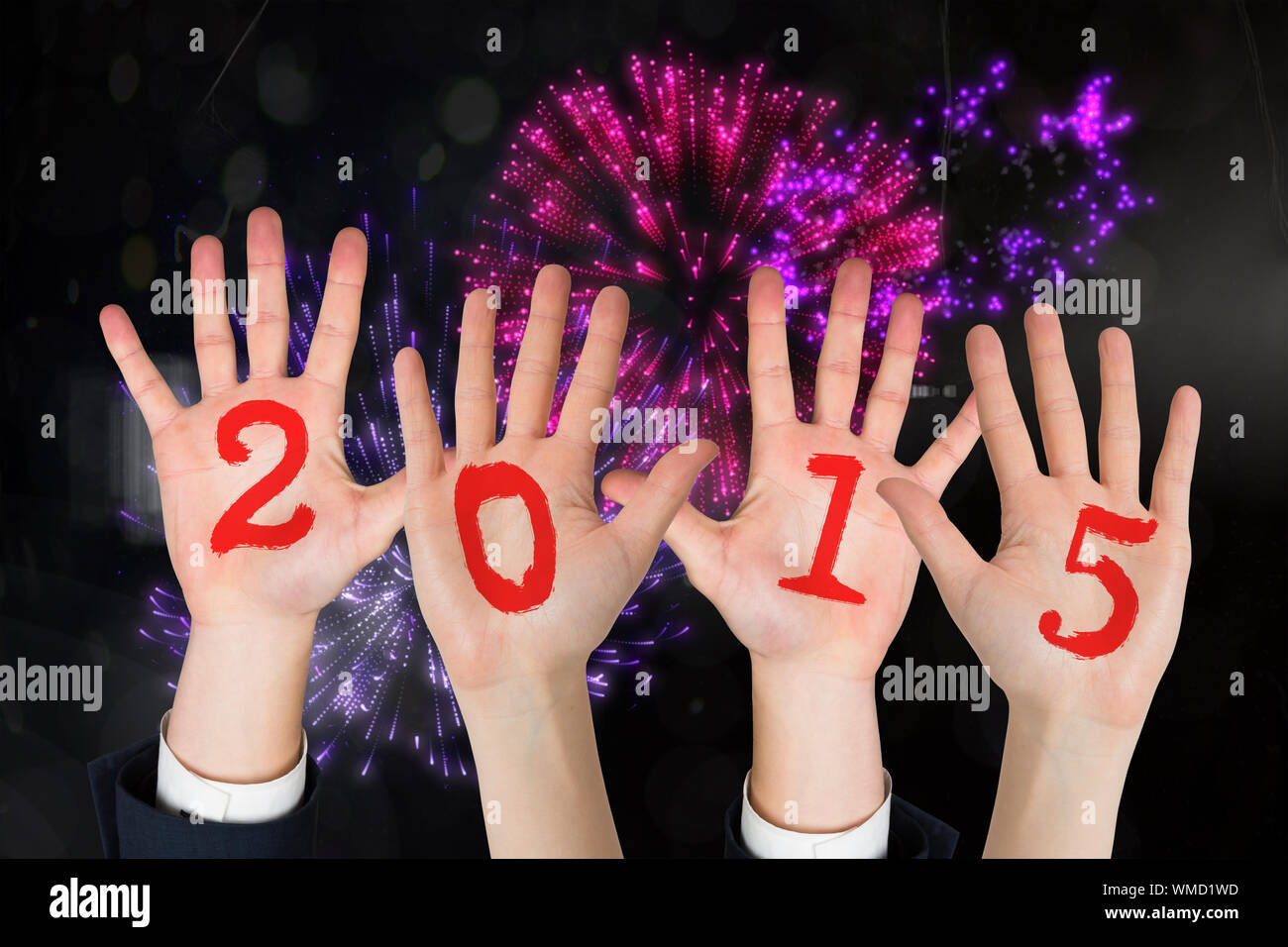 Business peoples hands against colourful fireworks exploding on black ...