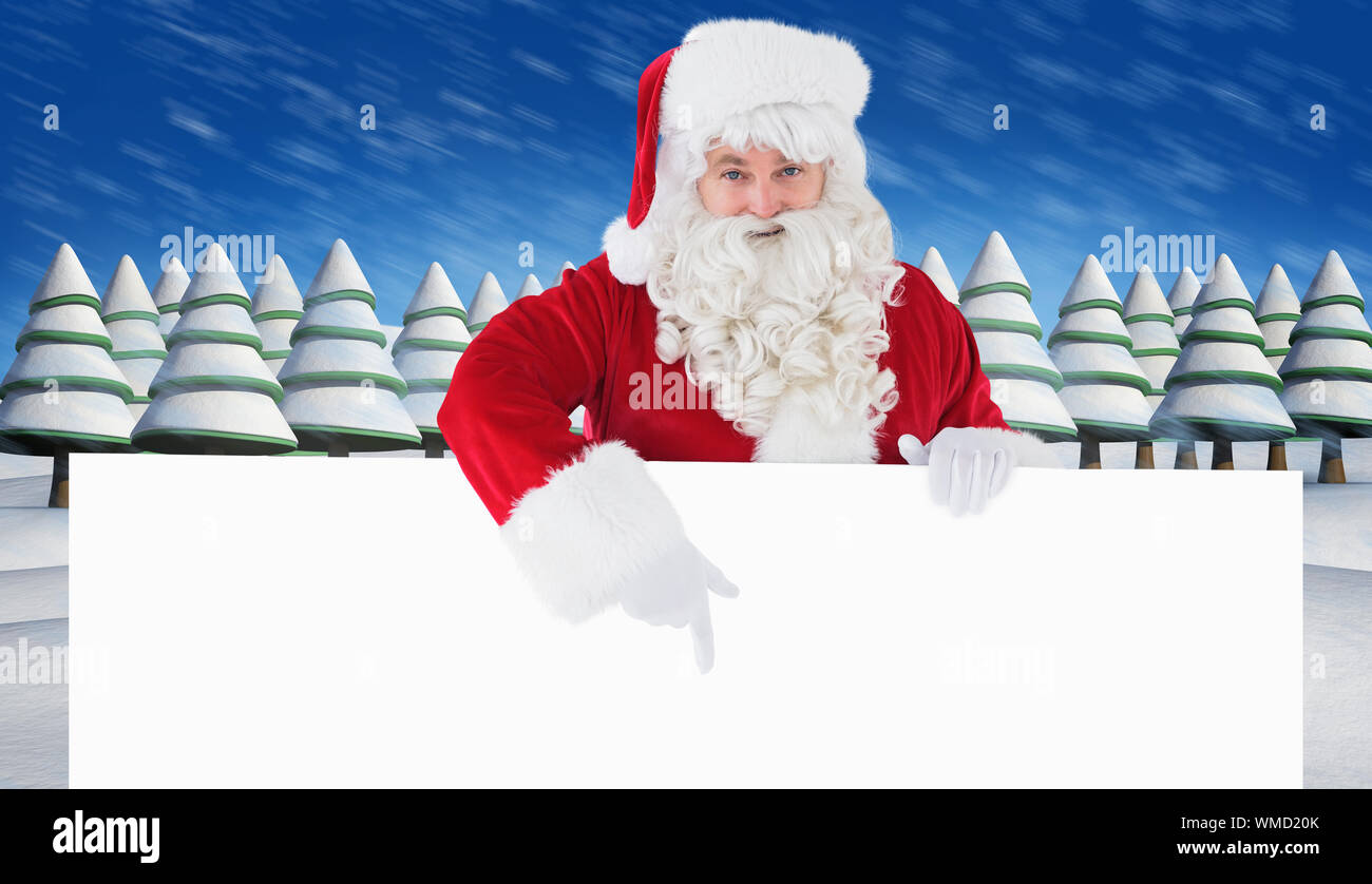 Joyful santa claus presenting sign against snowy landscape with fir ...