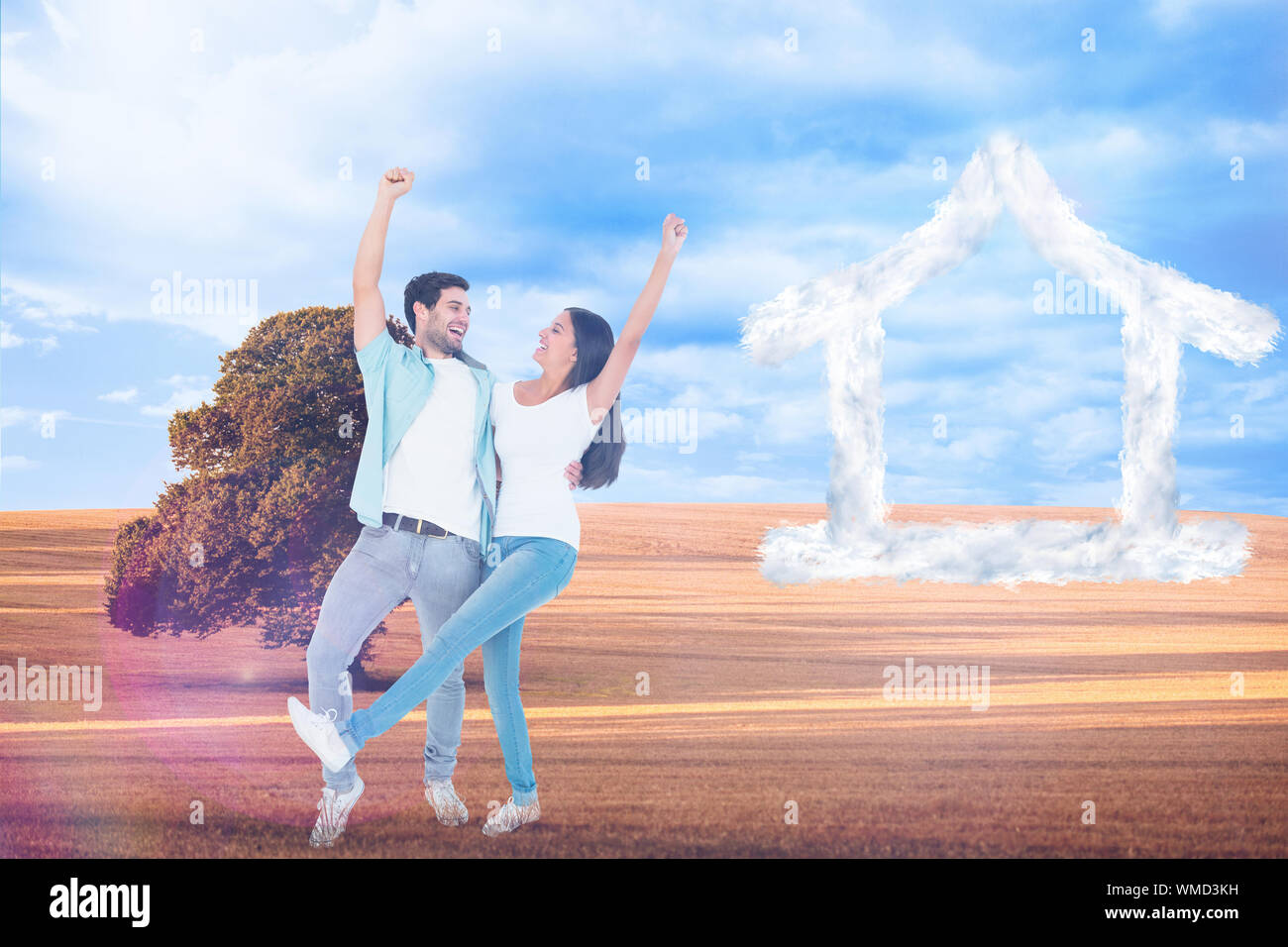 Happy casual couple cheering together against sunny brown landscape ...