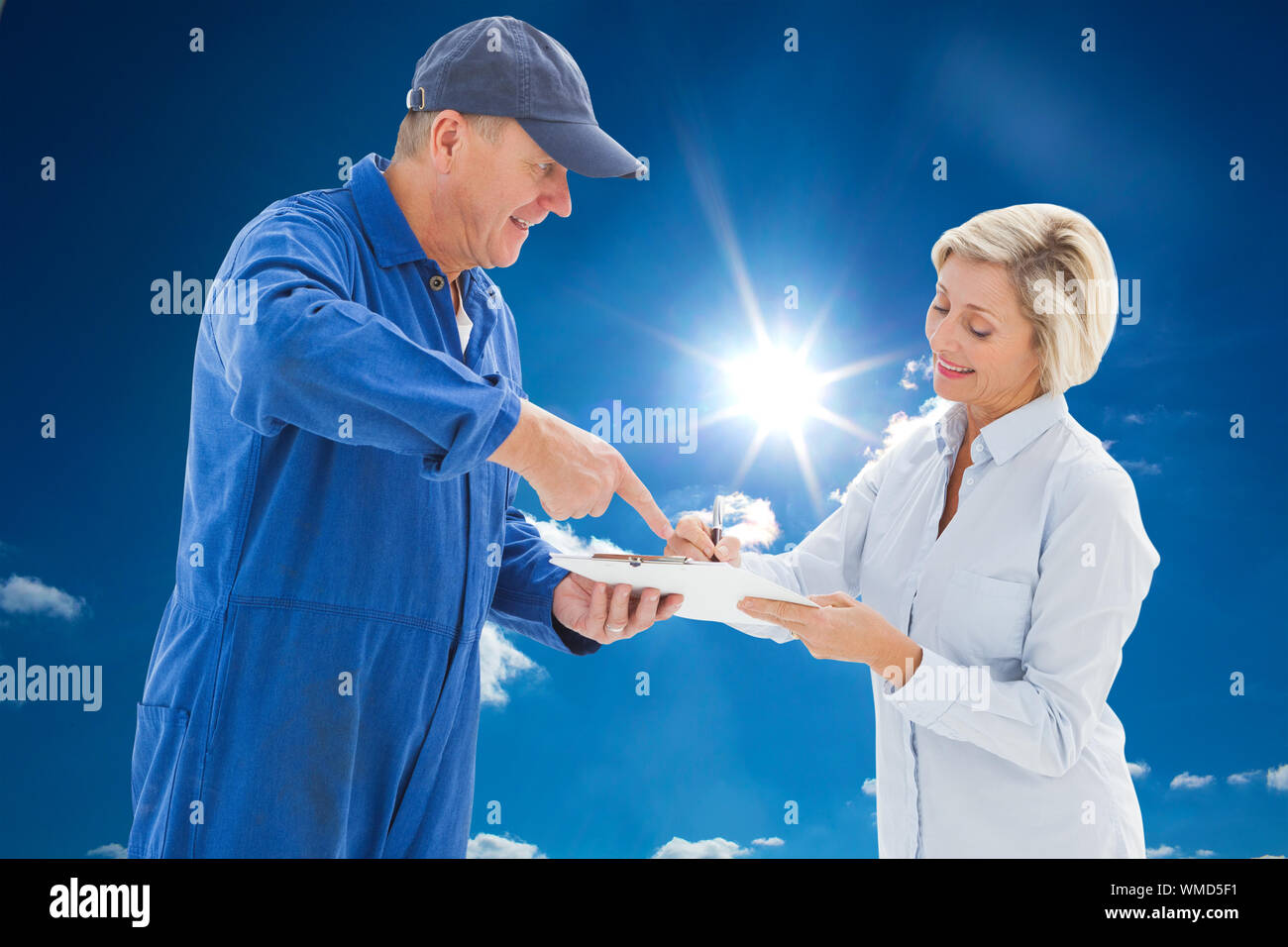 Happy delivery man with customer against cloudy sky with sunshine Stock ...