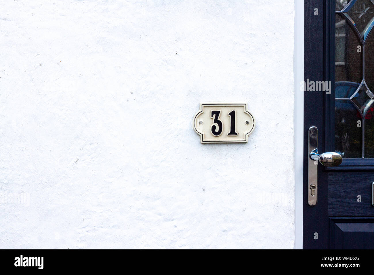 House number 31 on a white plaster wall Stock Photo - Alamy