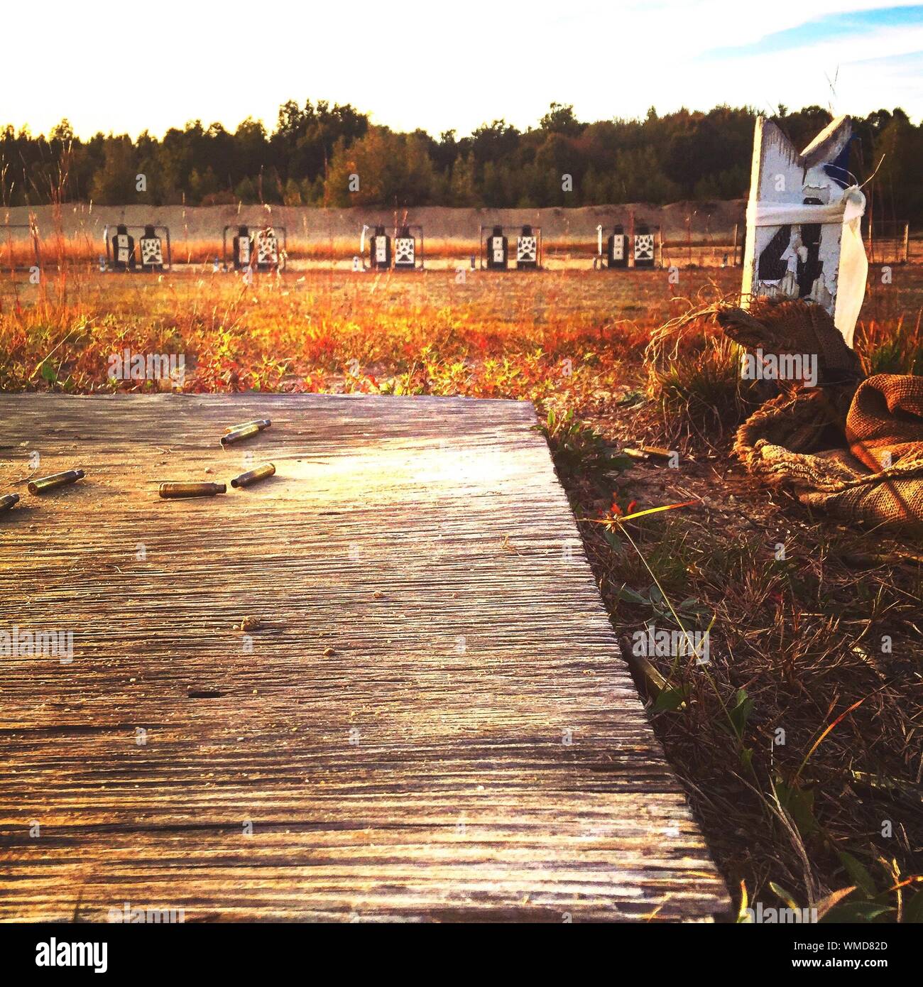 Bullet Shells On Wooden Platform Against Targets On Field Stock Photo ...