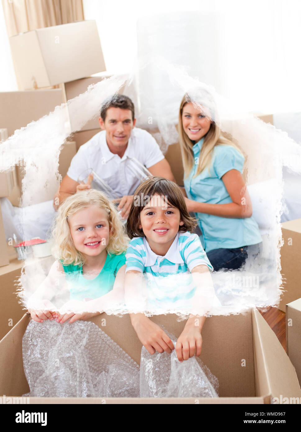 Smiling family packing boxes against house outline in clouds Stock ...