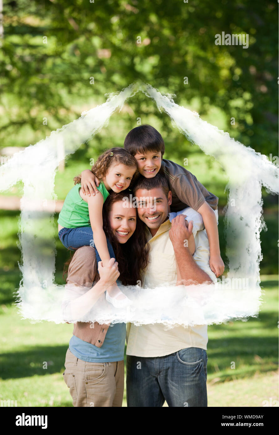 Parents giving children a piggyback against house outline in clouds ...