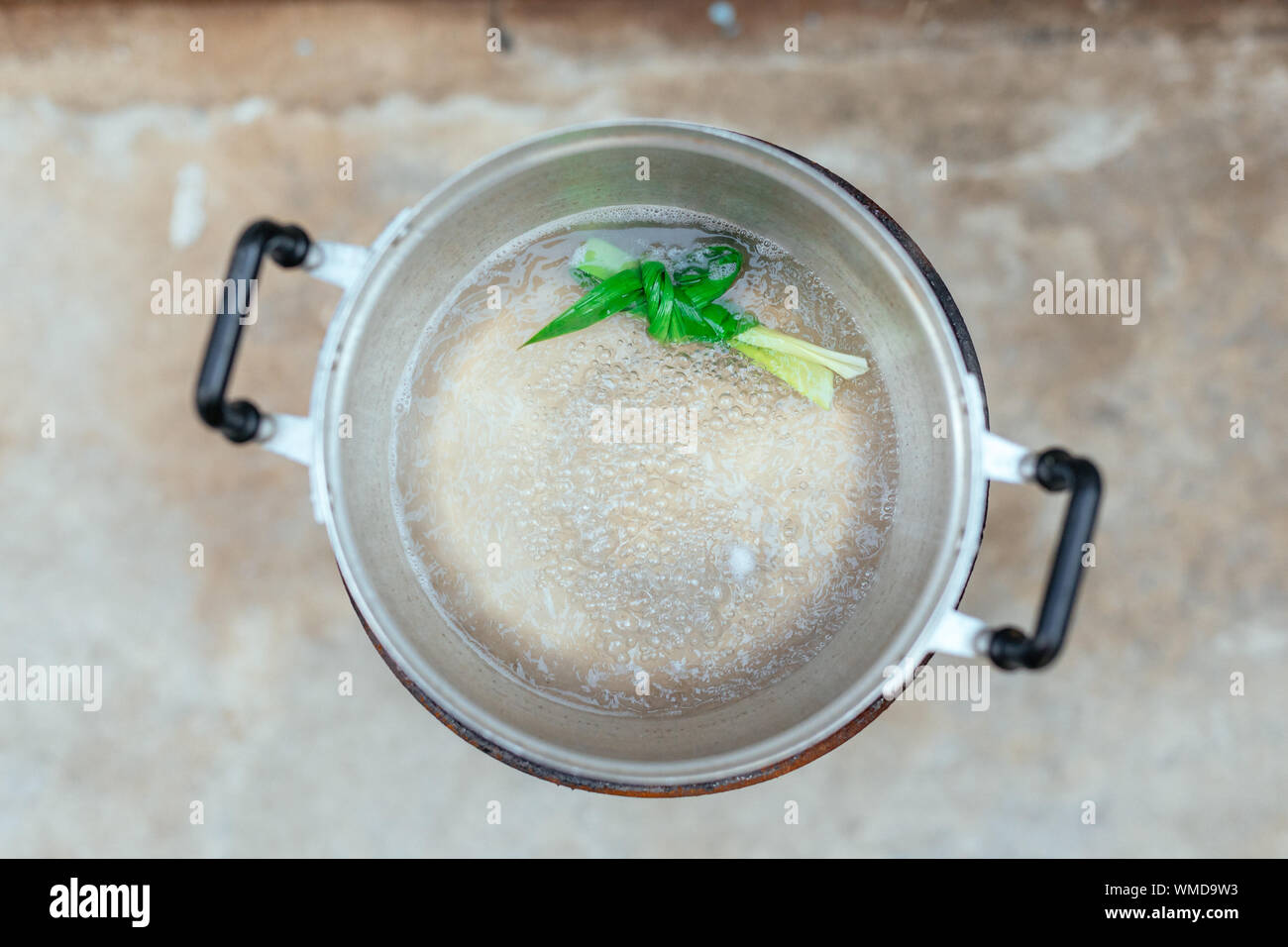 Top view of the boiling pot with a knot of Thai herbs Stock Photo - Alamy