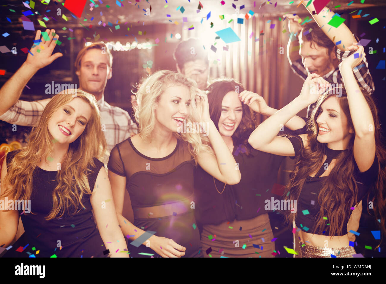 Stylish friends dancing and smiling against flying colours Stock Photo ...