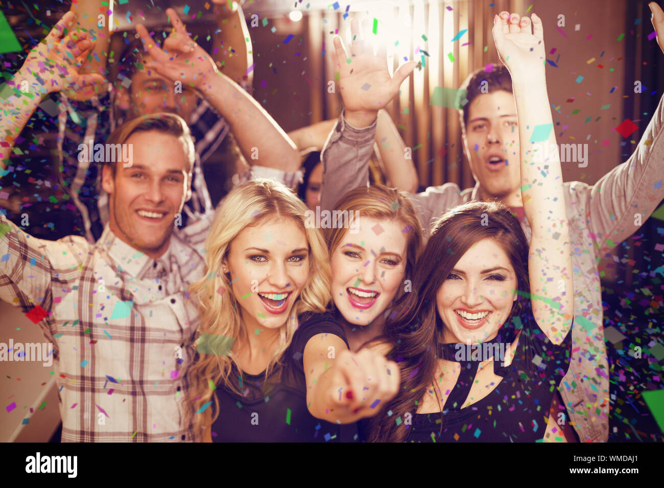 Stylish friends dancing and smiling against flying colours Stock Photo ...