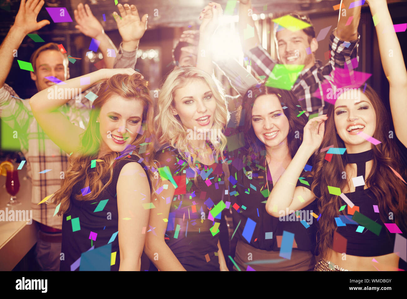 Stylish friends dancing and smiling against flying colours Stock Photo ...