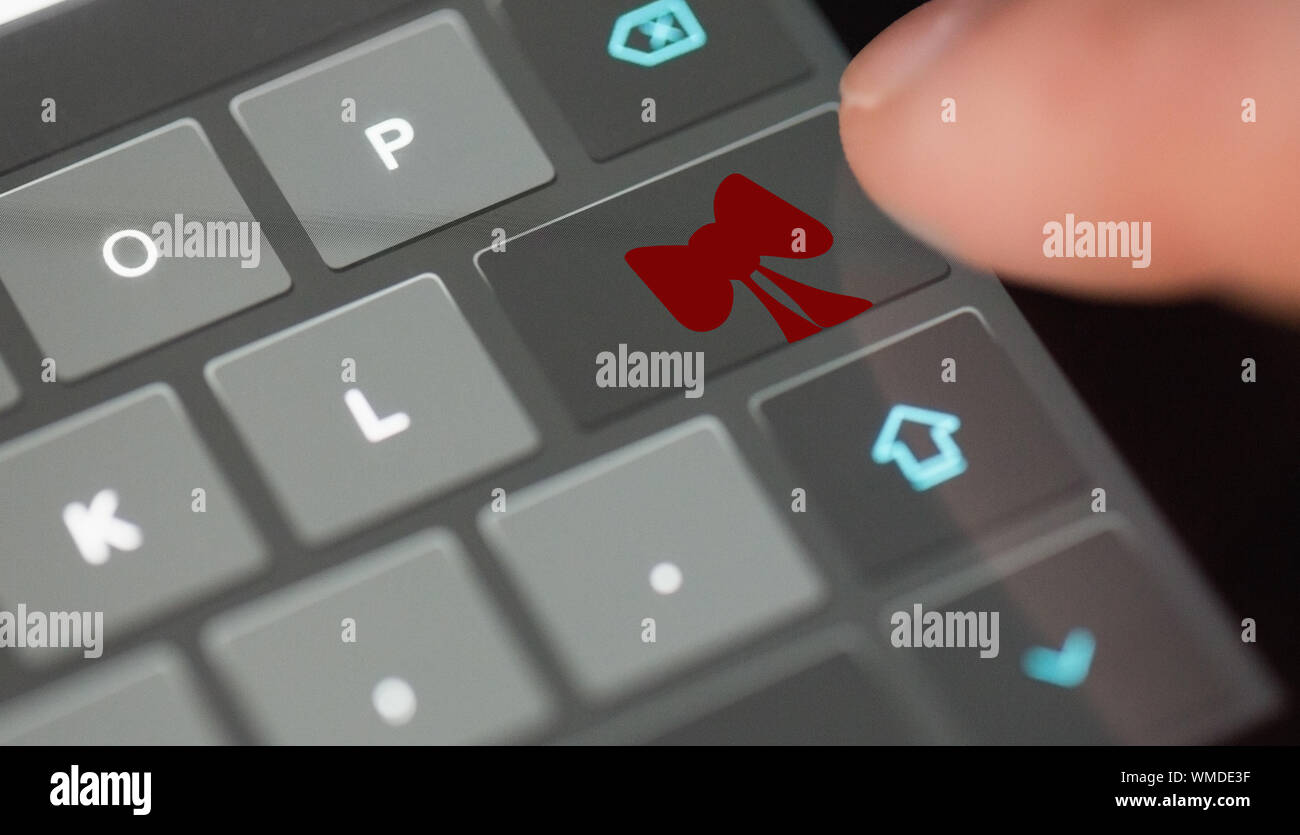 Ribbon against finger typing on touchscreen keyboard Stock Photo - Alamy