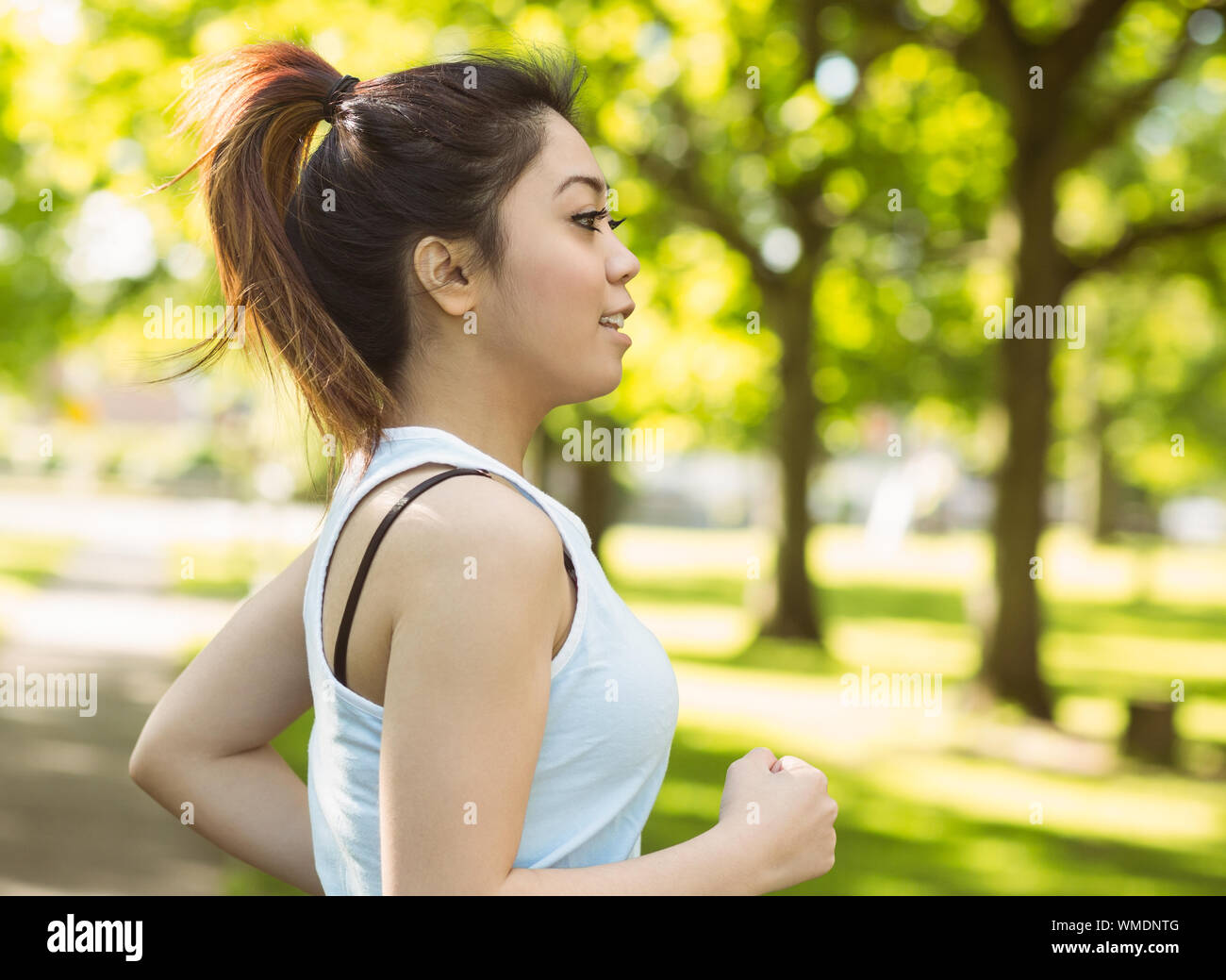 Healthy and beautiful young woman jogging in park Stock Photo - Alamy