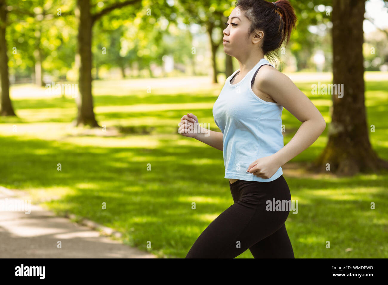 Healthy and beautiful young woman jogging in park Stock Photo - Alamy