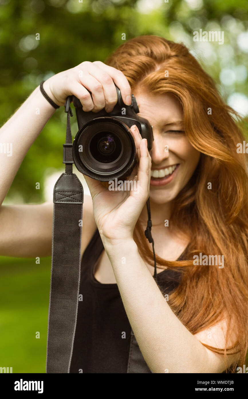 Portrait of beautiful female photographer at the park Stock Photo - Alamy